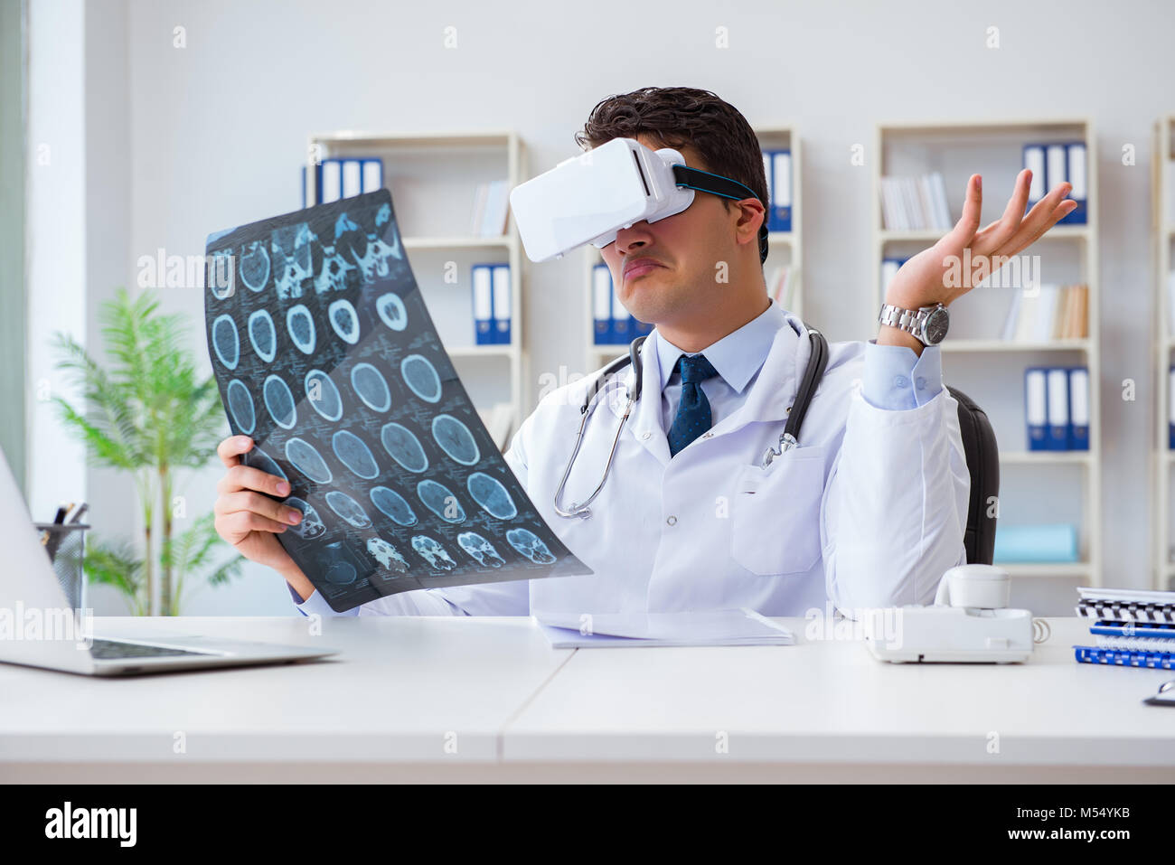 The young doctor looking at mri scan through vr glasses Stock Photo - Alamy