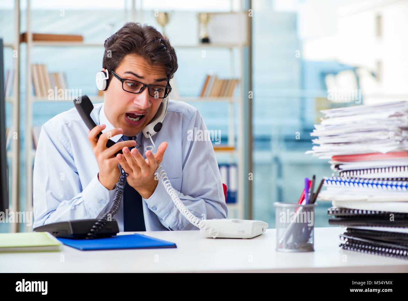 The unhappy angry call center worker frustrated with workload Stock ...