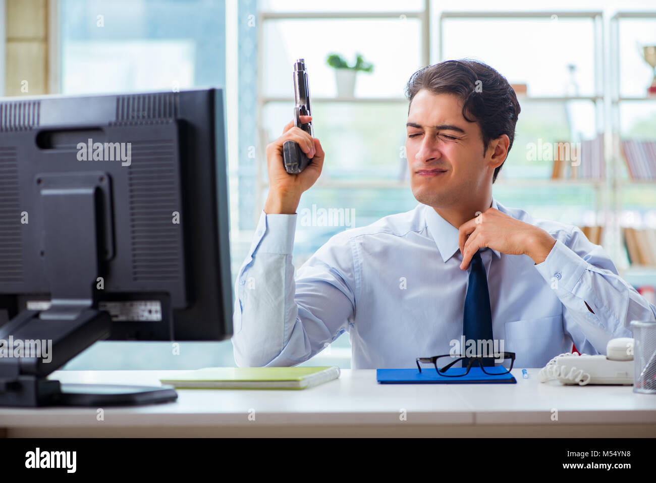 The angry businessman with gun thinking of committing suicide Stock ...