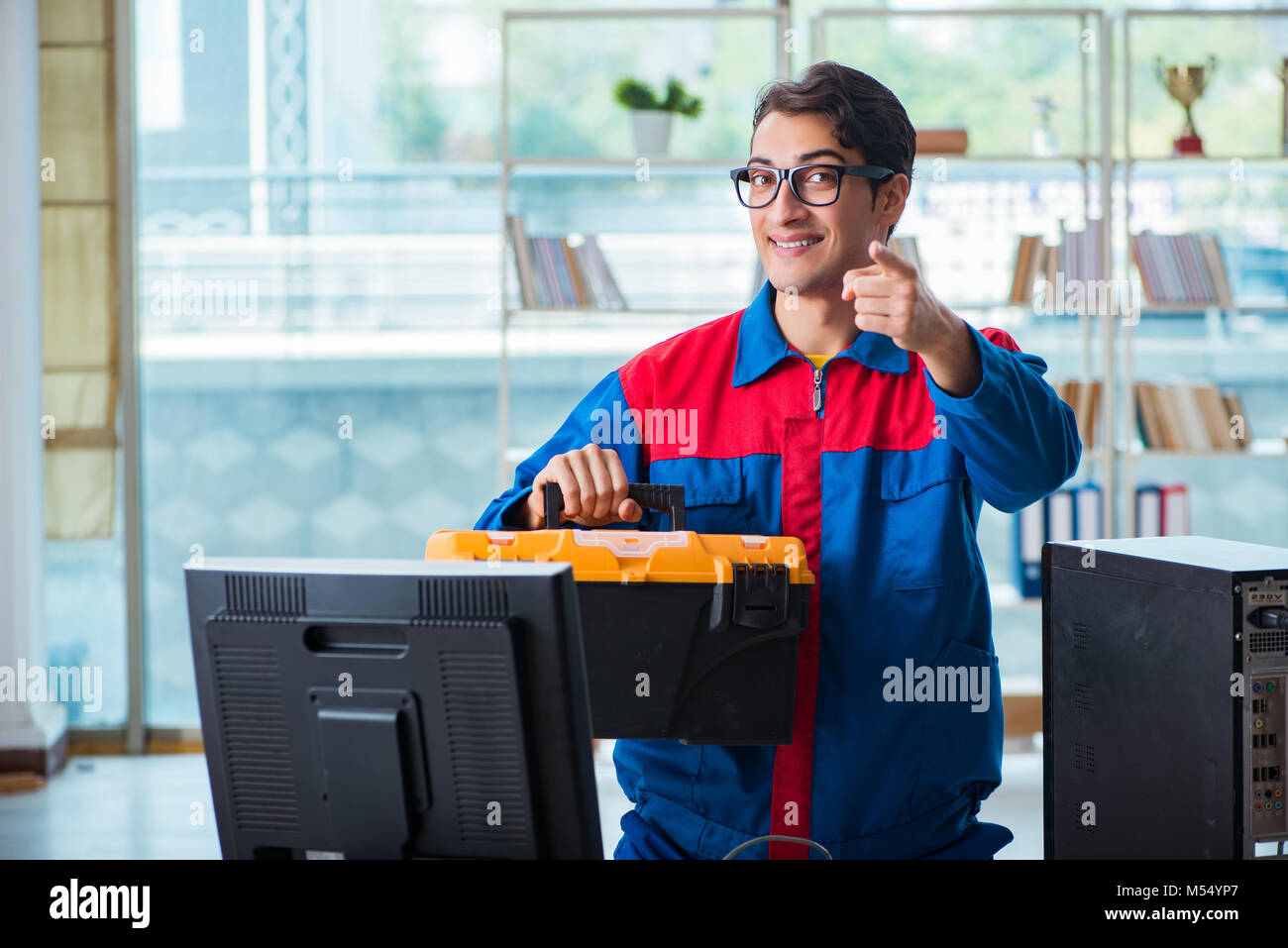 The computer repairman working on repairing computer in it workshop ...