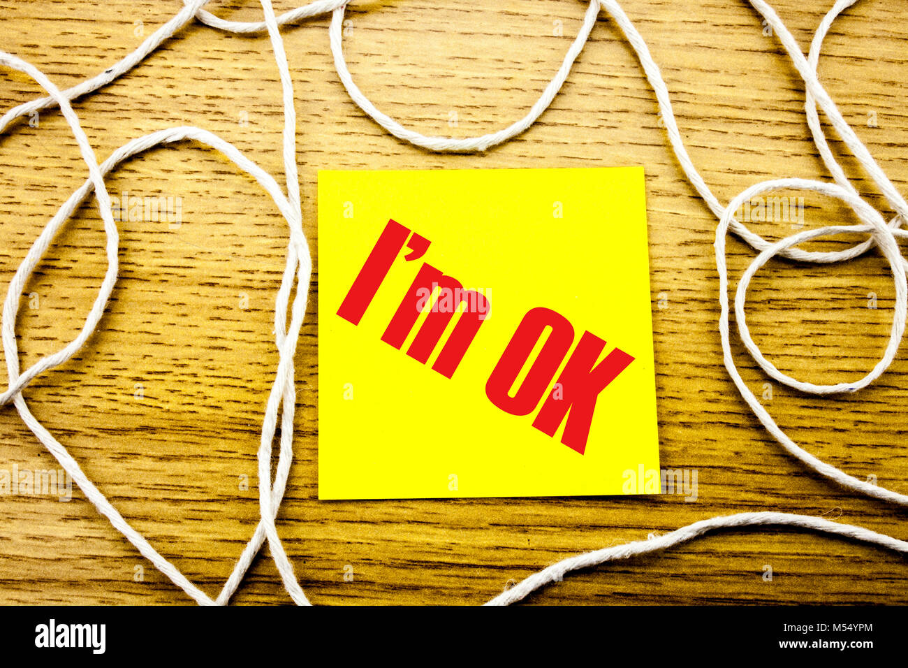 I am OK word on yellow sticky note in wooden background. Bussines ...