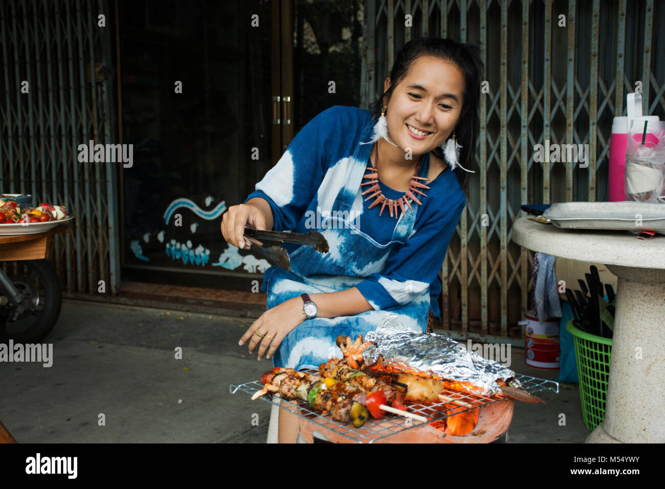 Thai women people cooking grilled meat and roasted seafood BBQ on Stove ...