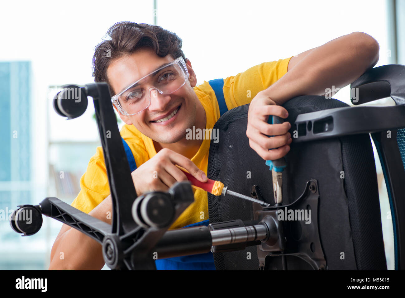 The furniture repairman working on repairing the chair Stock Photo - Alamy