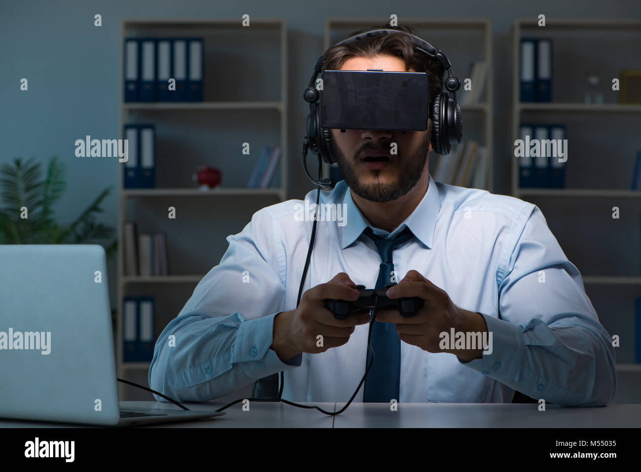 The businessman gamer staying late to play games Stock Photo - Alamy