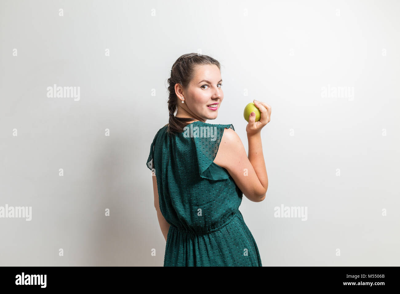 Woman looks over shoulder hi-res stock photography and images - Alamy