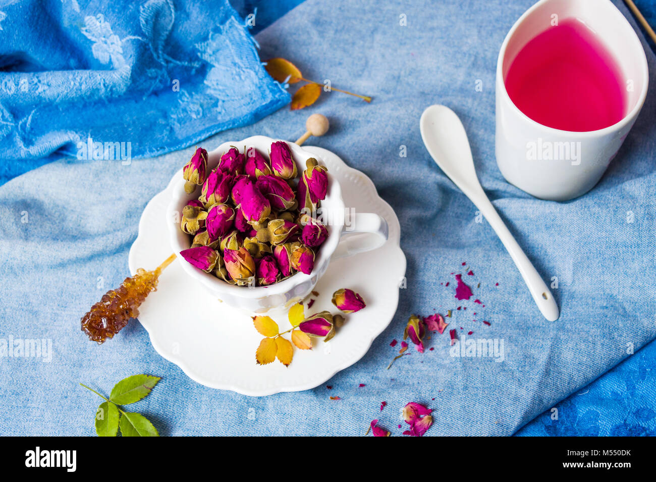Rose tea buds in a white tea cup Stock Photo - Alamy