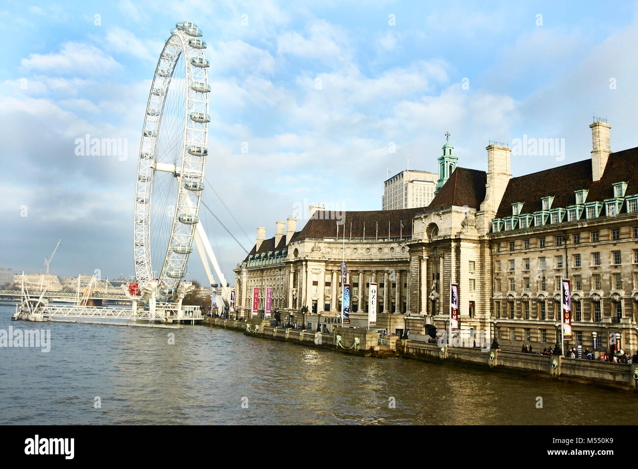 a view of county hall and the london eye from across the thames in ...