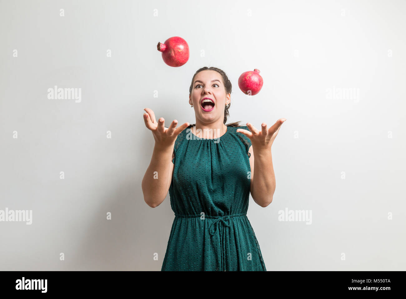 Young girl throwing fruits Stock Photo - Alamy