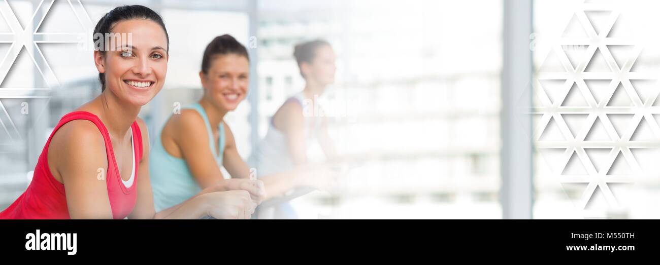 Athletic fit women in gym with triangle interface Stock Photo - Alamy
