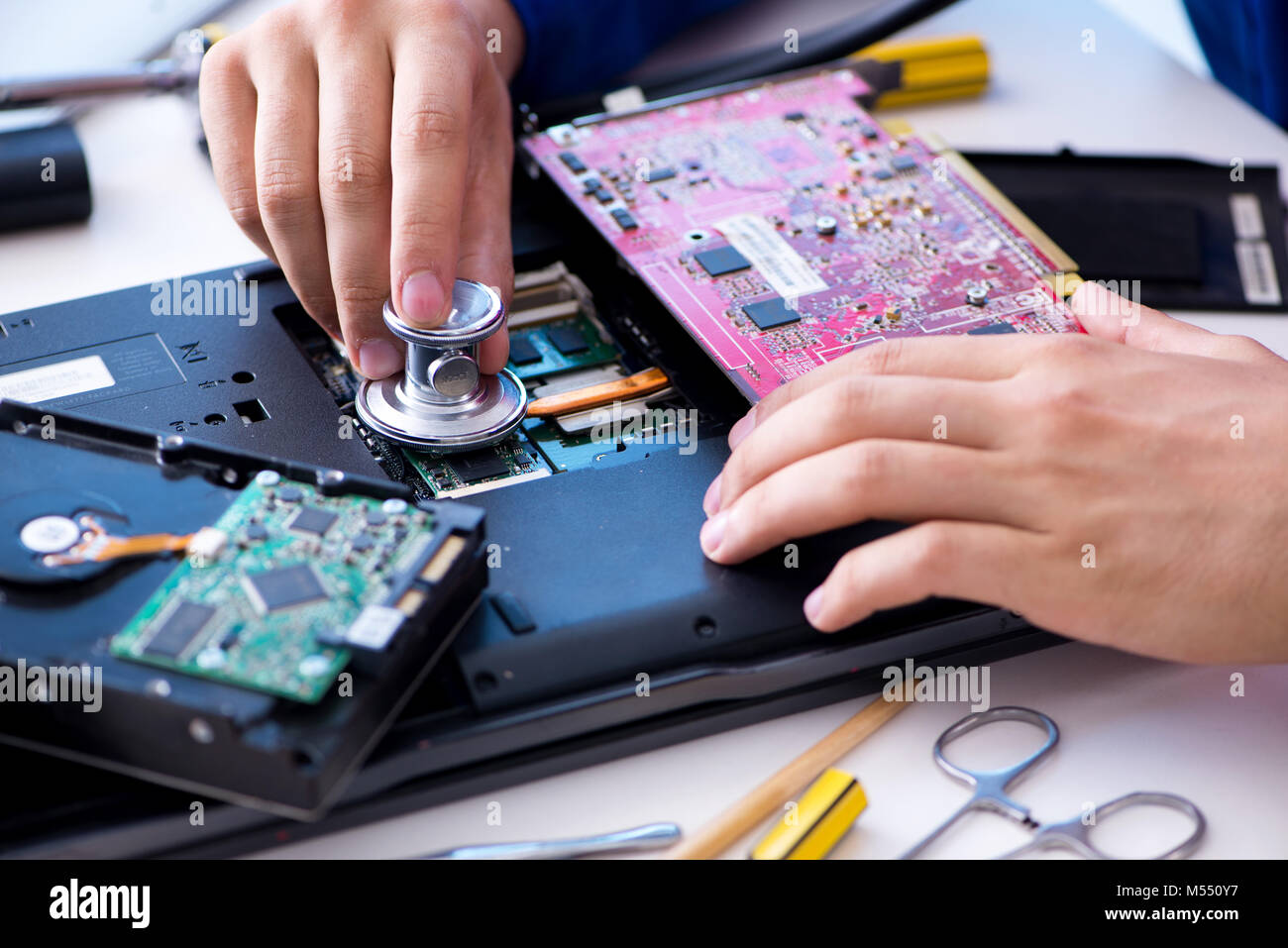 Repairman working in technical support fixing computer laptop tr Stock ...