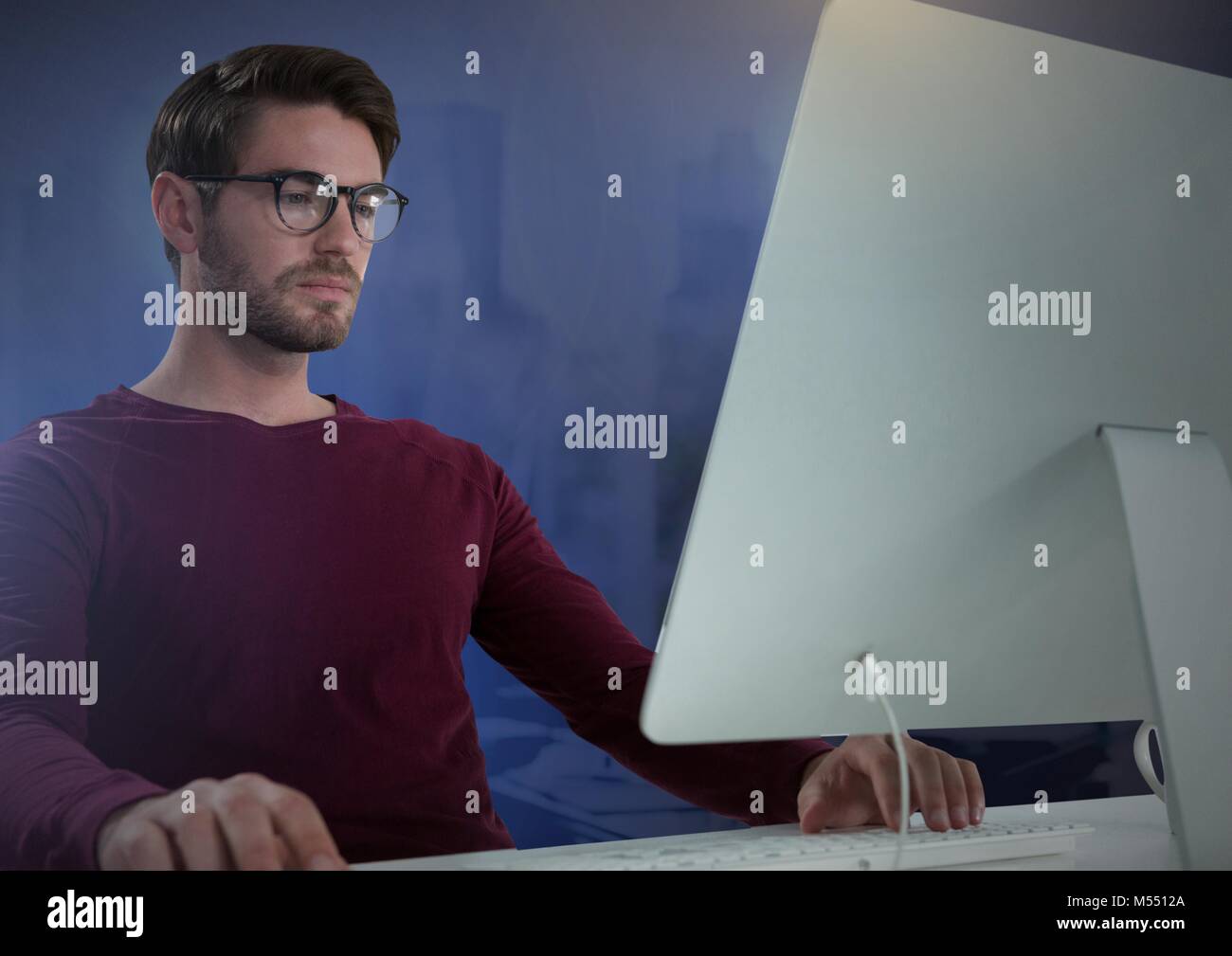 Businessman working on laptop with purple background Stock Photo - Alamy