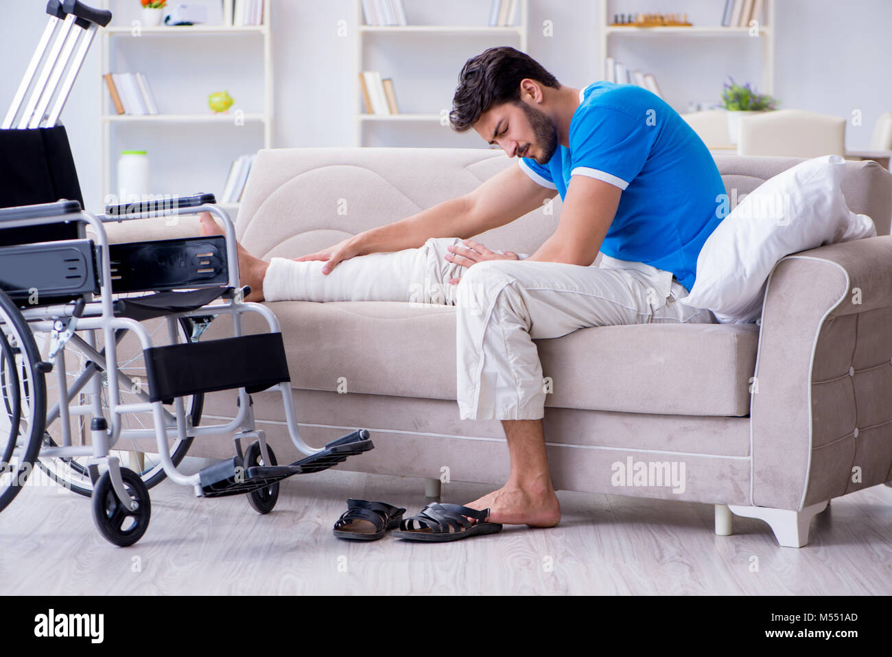 Injured young man recovering at home Stock Photo - Alamy