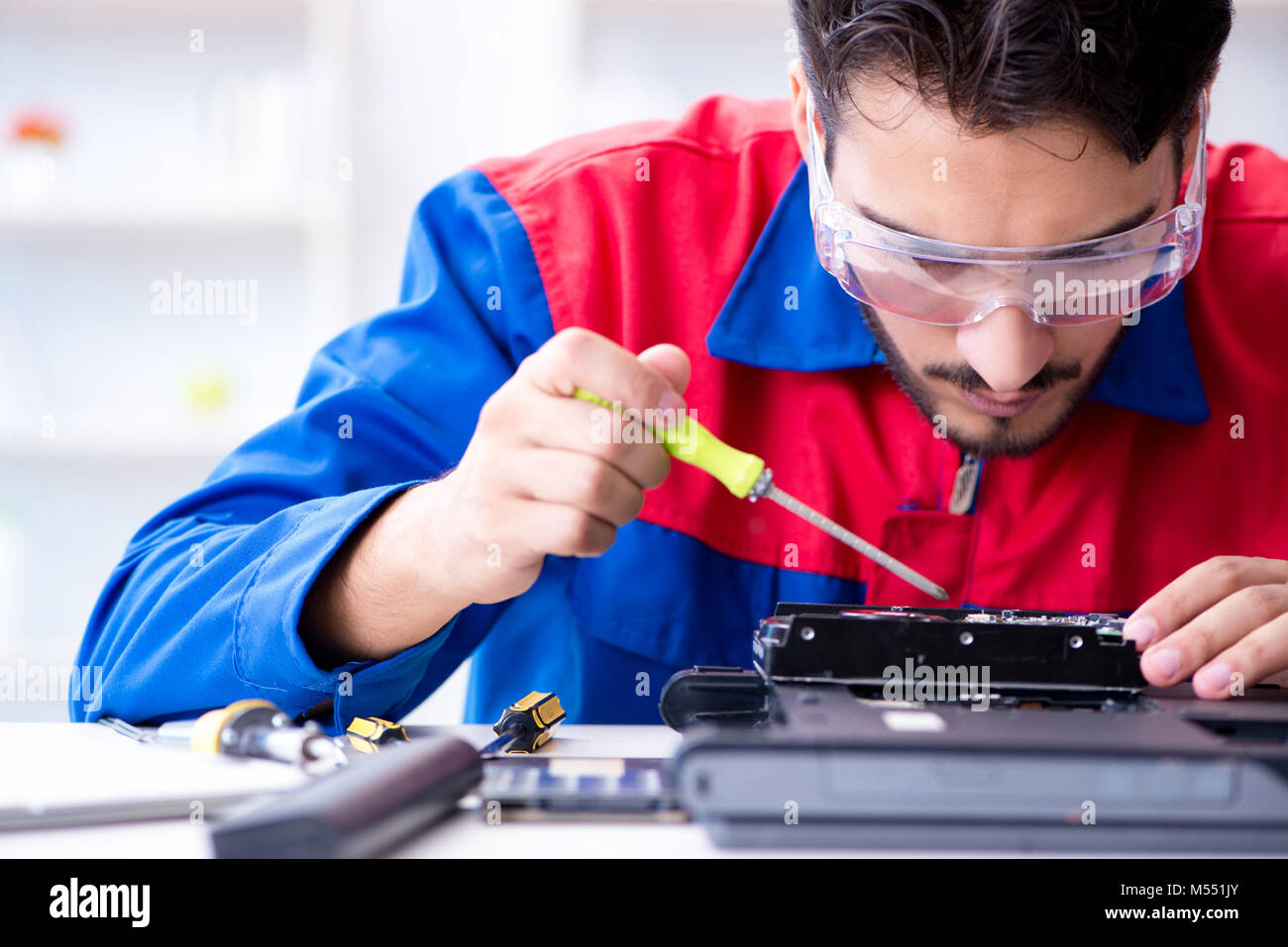 Repairman working in technical support fixing computer laptop tr Stock ...