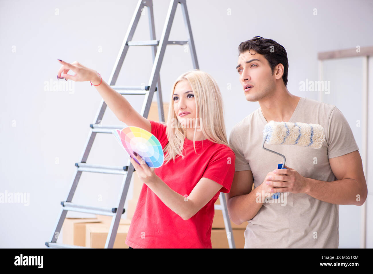 Young family doing painting job during home renovation Stock Photo - Alamy