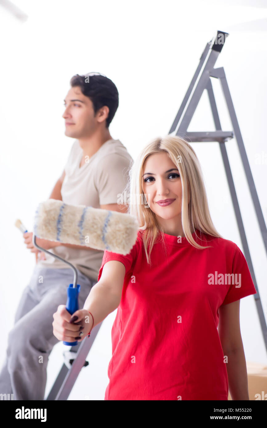 Young family doing painting job during home renovation Stock Photo - Alamy