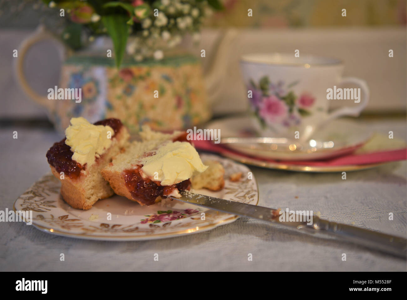 afternoon tea with vintage floral crockery scone cream and jam Stock ...
