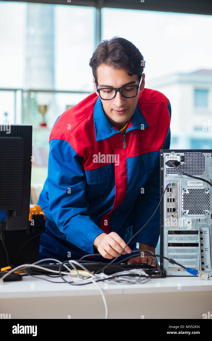 Computer repairman working on repairing computer in IT workshop Stock ...
