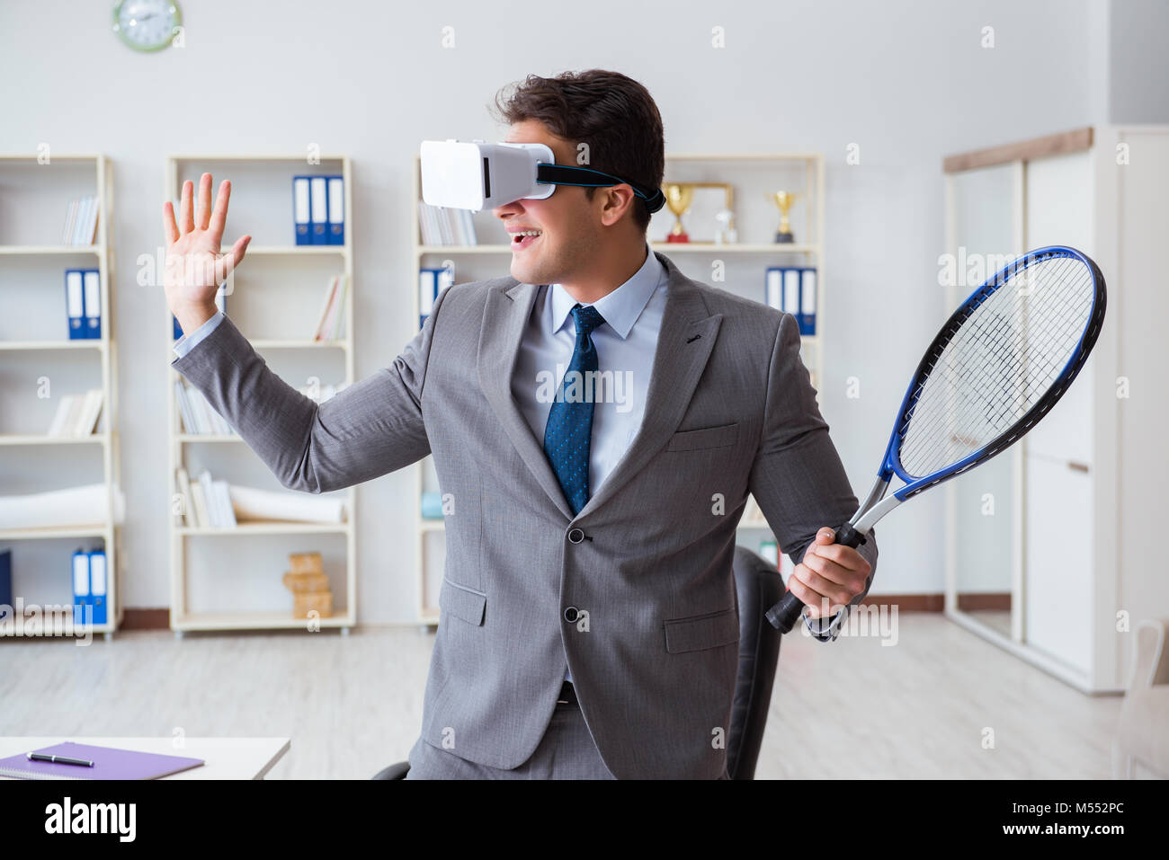 Businessman playing virtual reality tennis in office with VR gog Stock ...