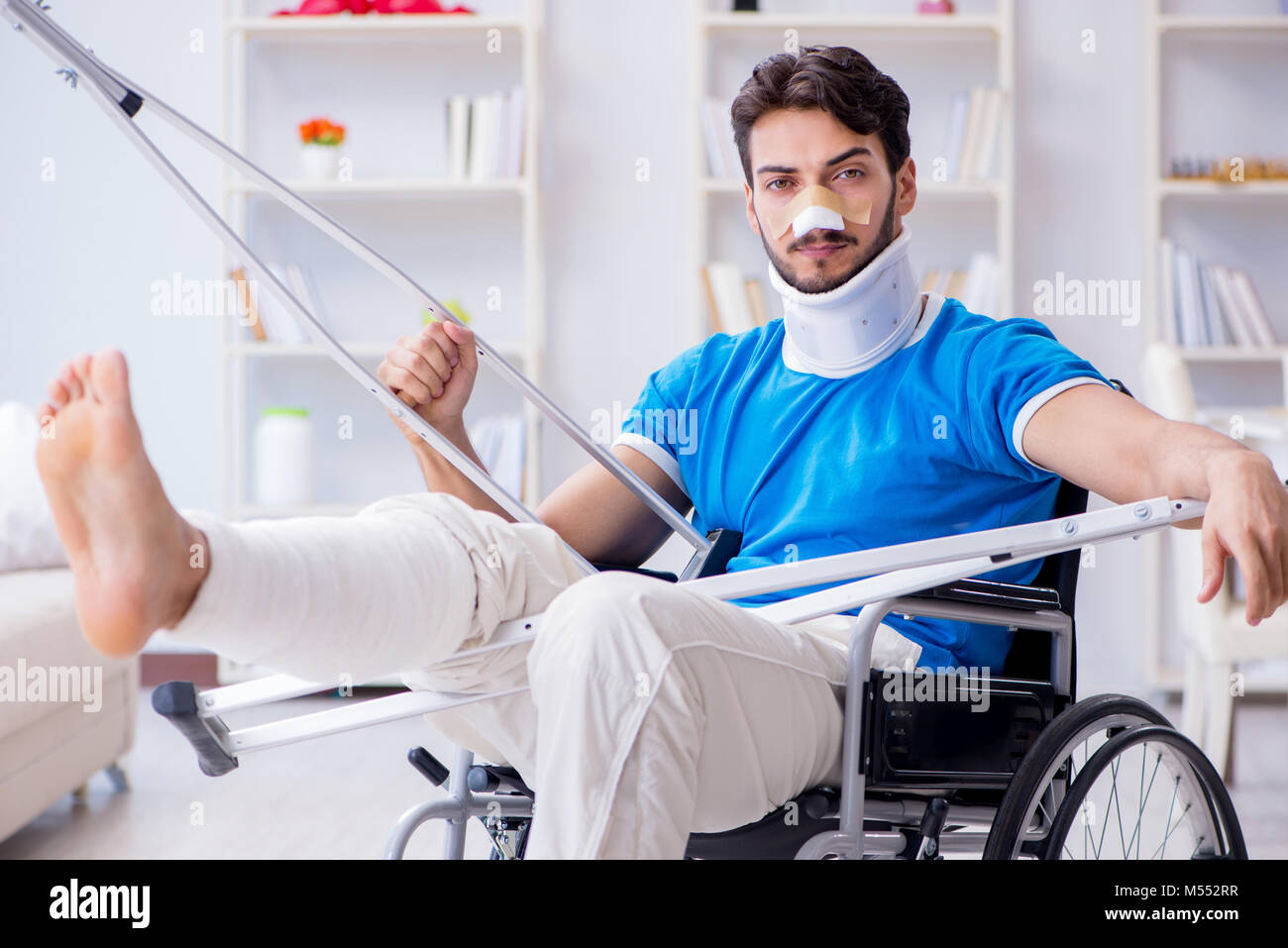 Injured young man recovering at home Stock Photo - Alamy