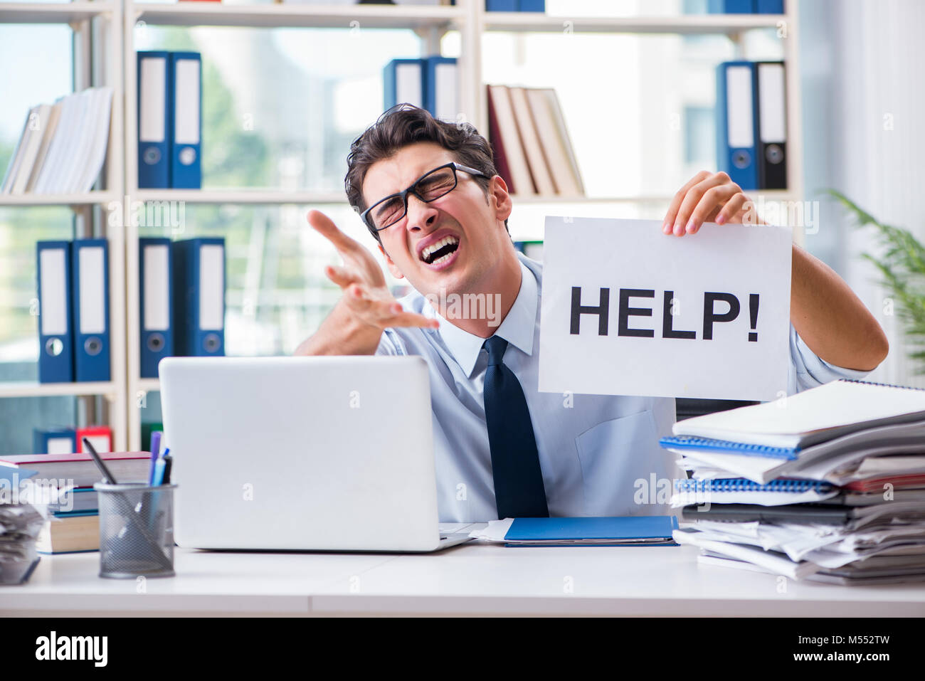 Young businessman asking for help in office Stock Photo - Alamy