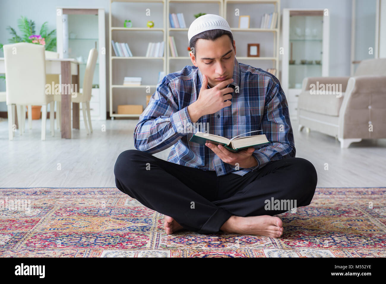 Young muslim man praying at home Stock Photo - Alamy
