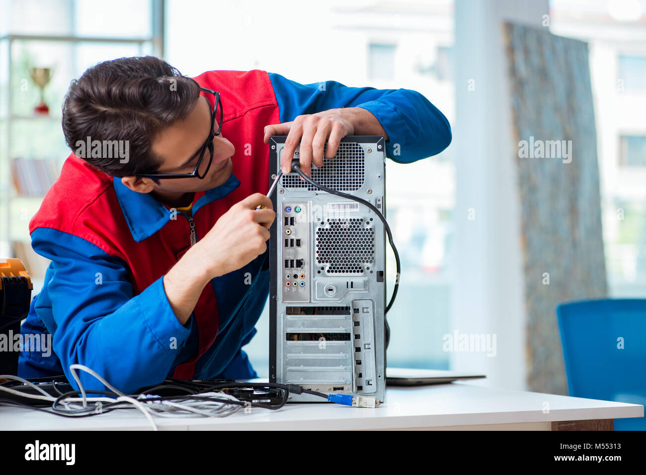 Computer repairman working on repairing computer in IT workshop Stock ...