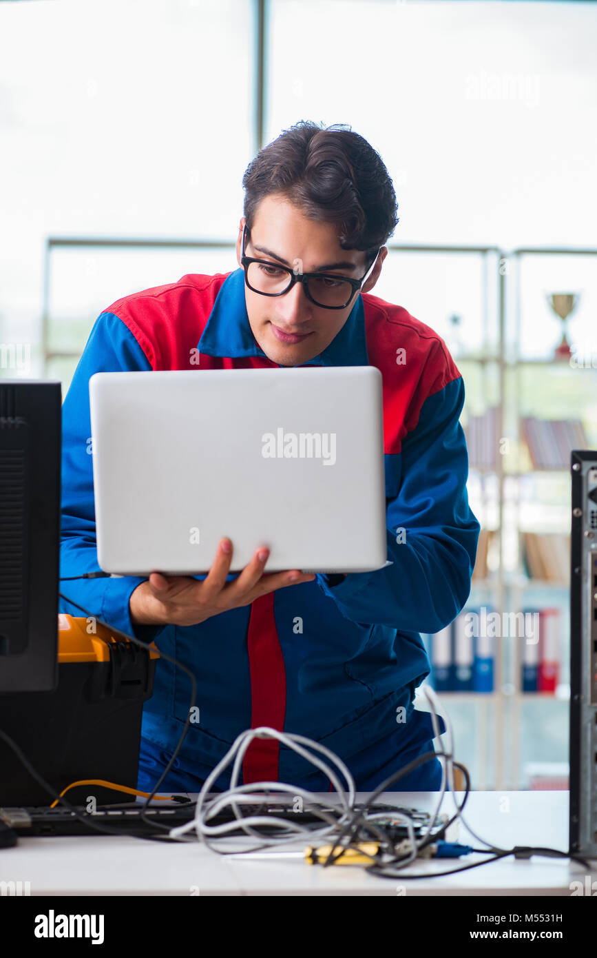 Computer repairman working on repairing computer in IT workshop Stock ...