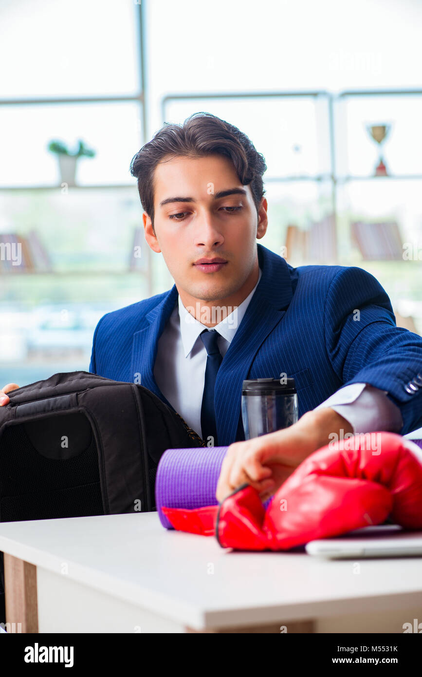 Man with boxing gloves in the office Stock Photo - Alamy