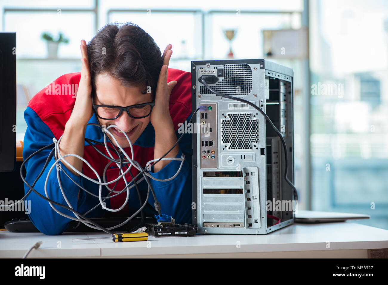 Computer repairman working on repairing computer in IT workshop Stock ...