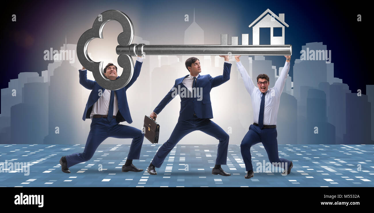 Businessmen holding giant key in real estate concept Stock Photo - Alamy