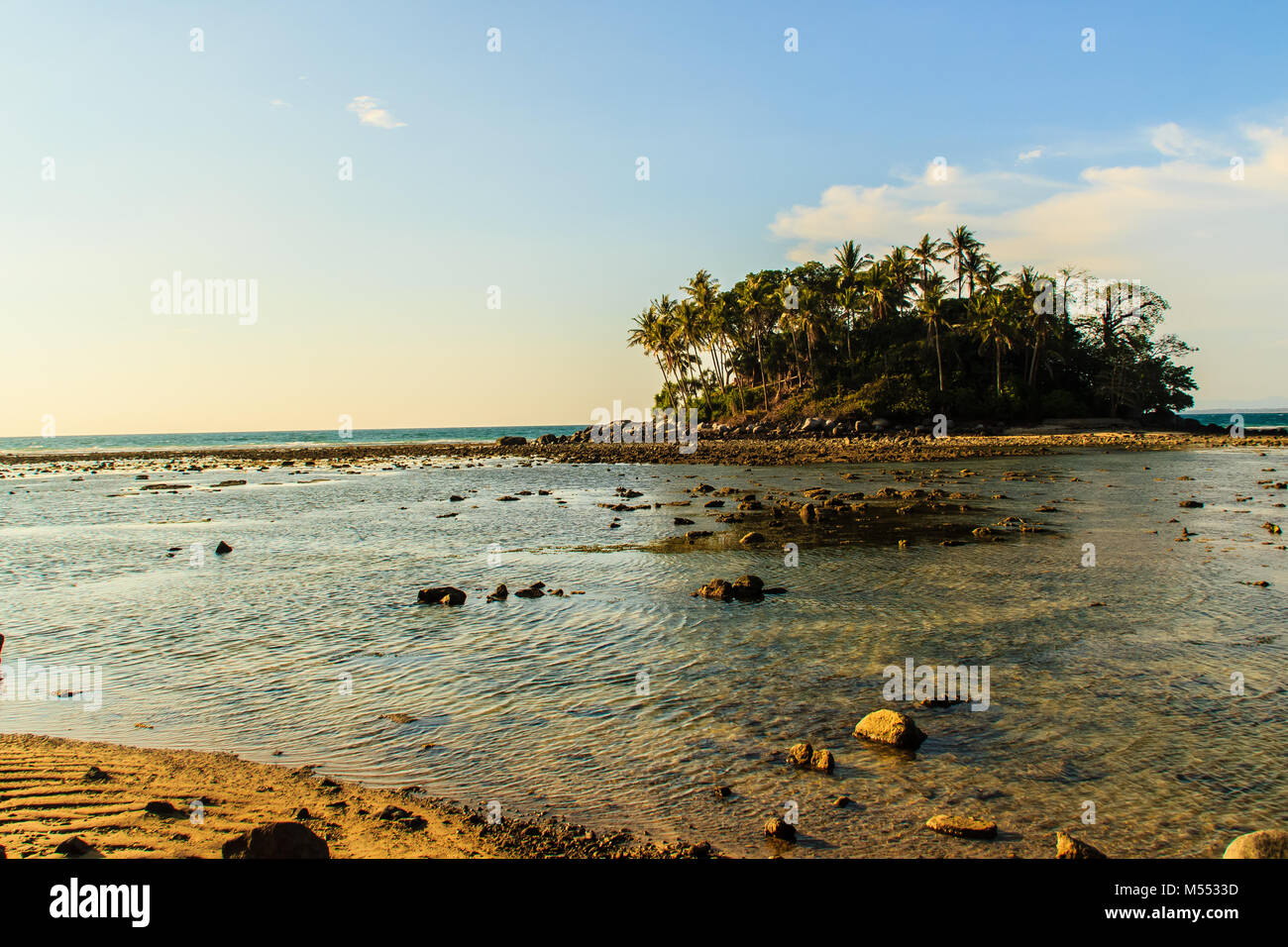 Lonely remote island with rock beach and tree when the sea water ...