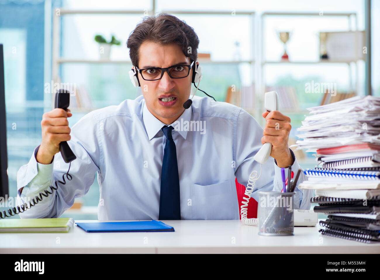 Unhappy angry call center worker frustrated with workload Stock Photo ...