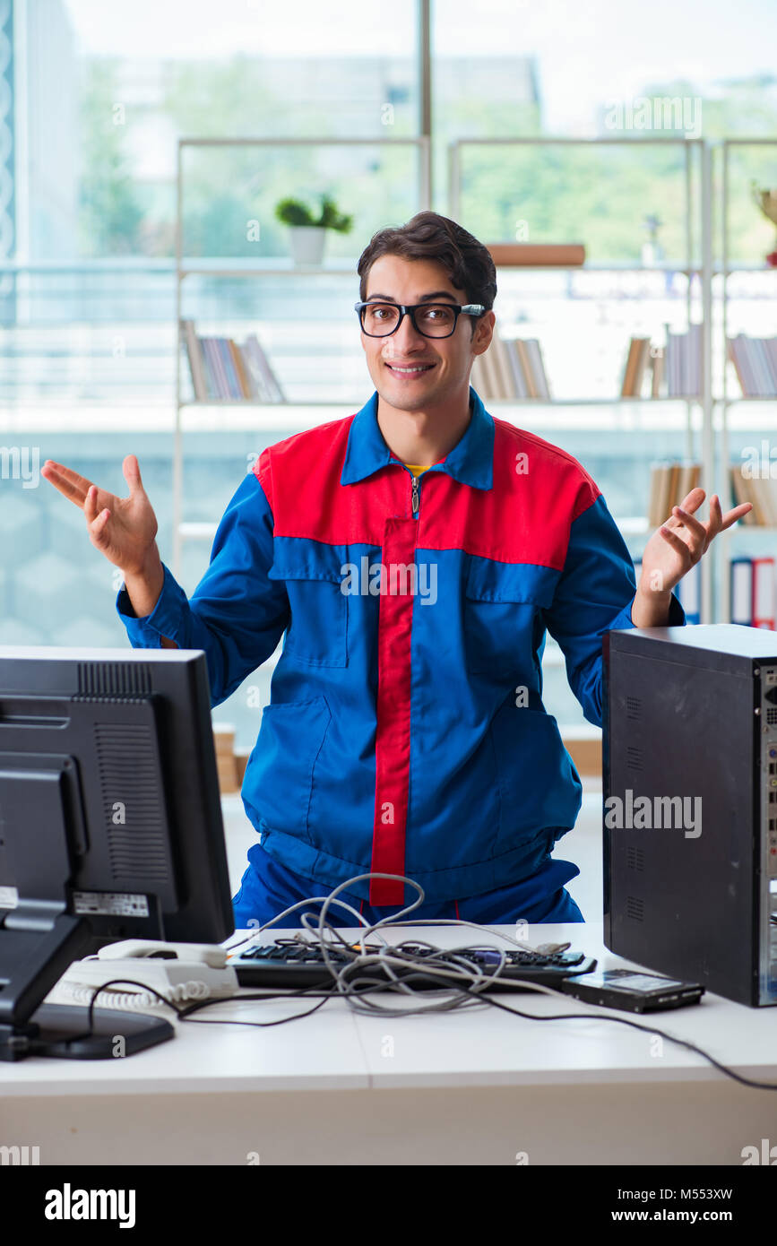 Computer repairman working on repairing computer in IT workshop Stock ...