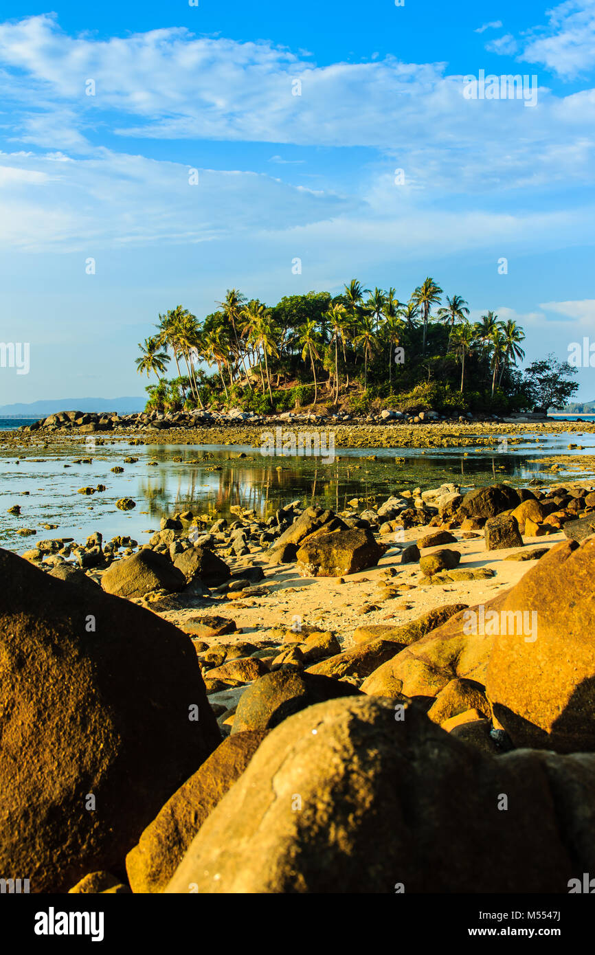Lonely remote island with rock beach and tree when the sea water ...