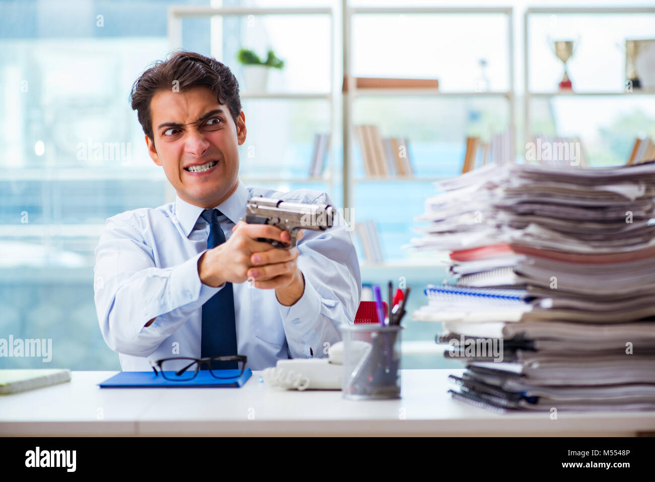 Angry businessman with gun thinking of committing suicide Stock Photo ...