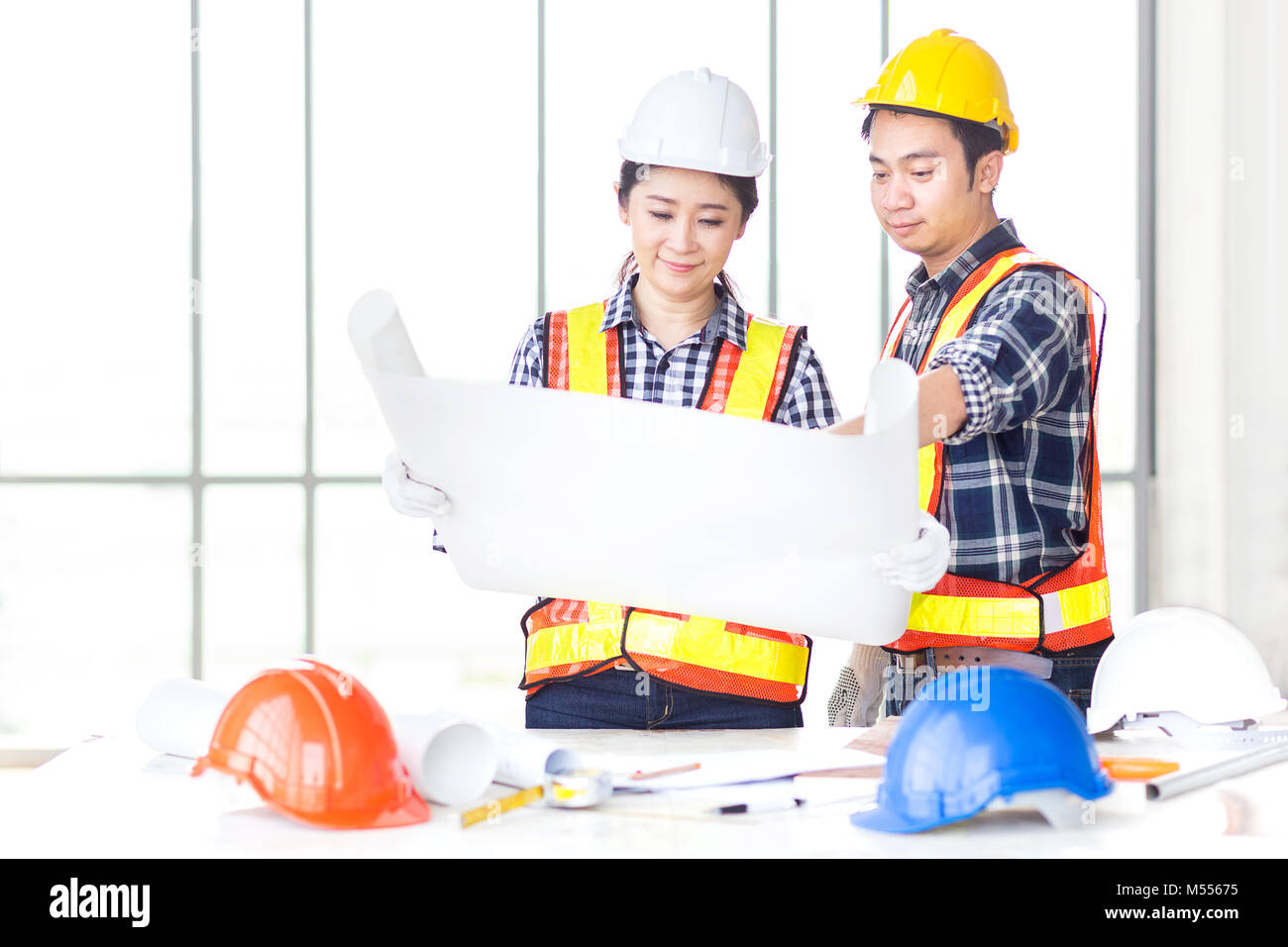 female engineer look and discuss with male engineer, team work, about ...