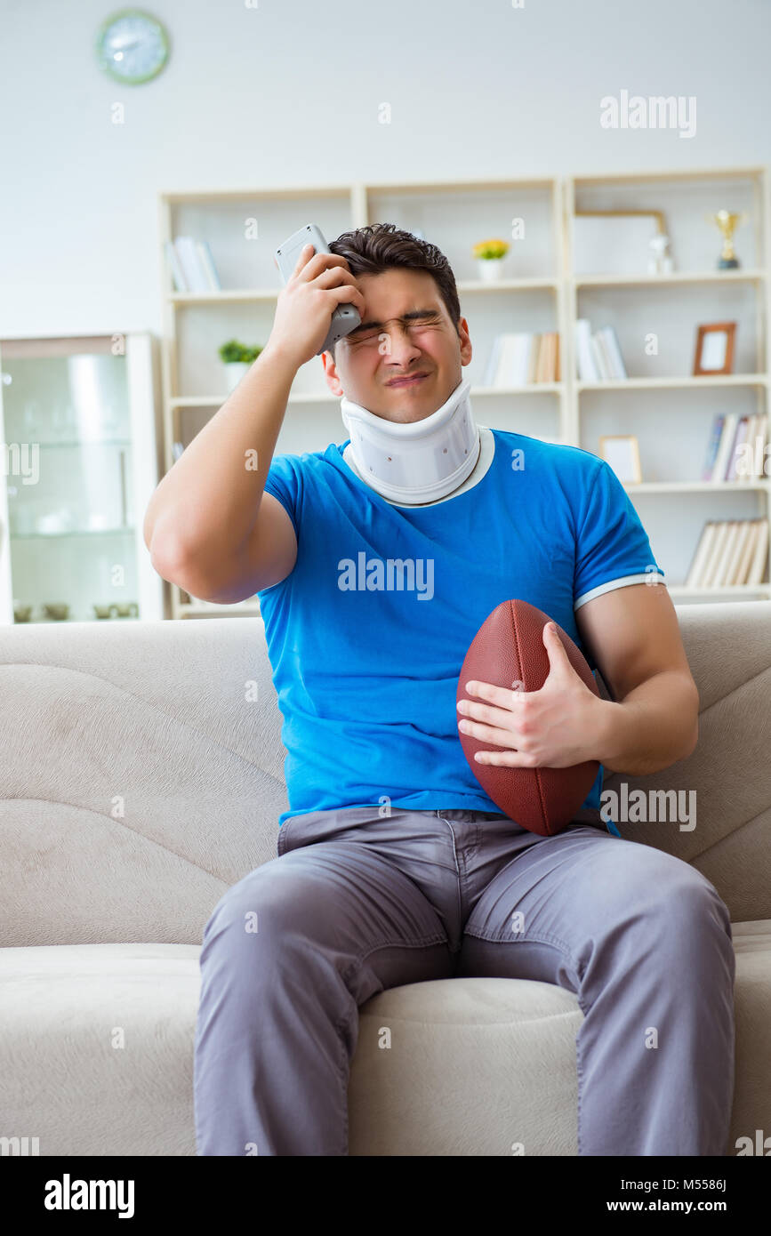 The man with neck injury watching american football at home Stock Photo ...