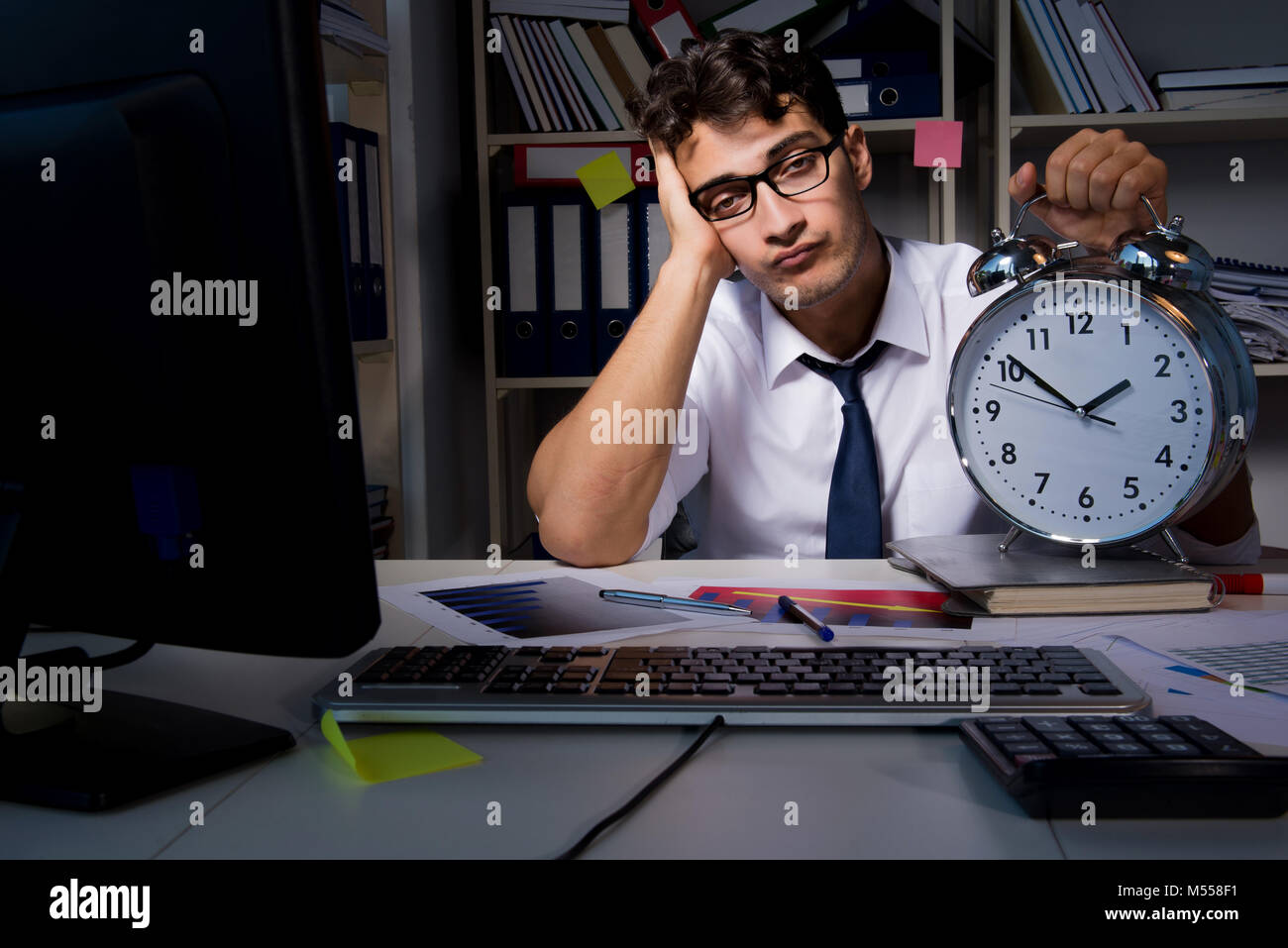 The man businessman working late hours in the office Stock Photo - Alamy