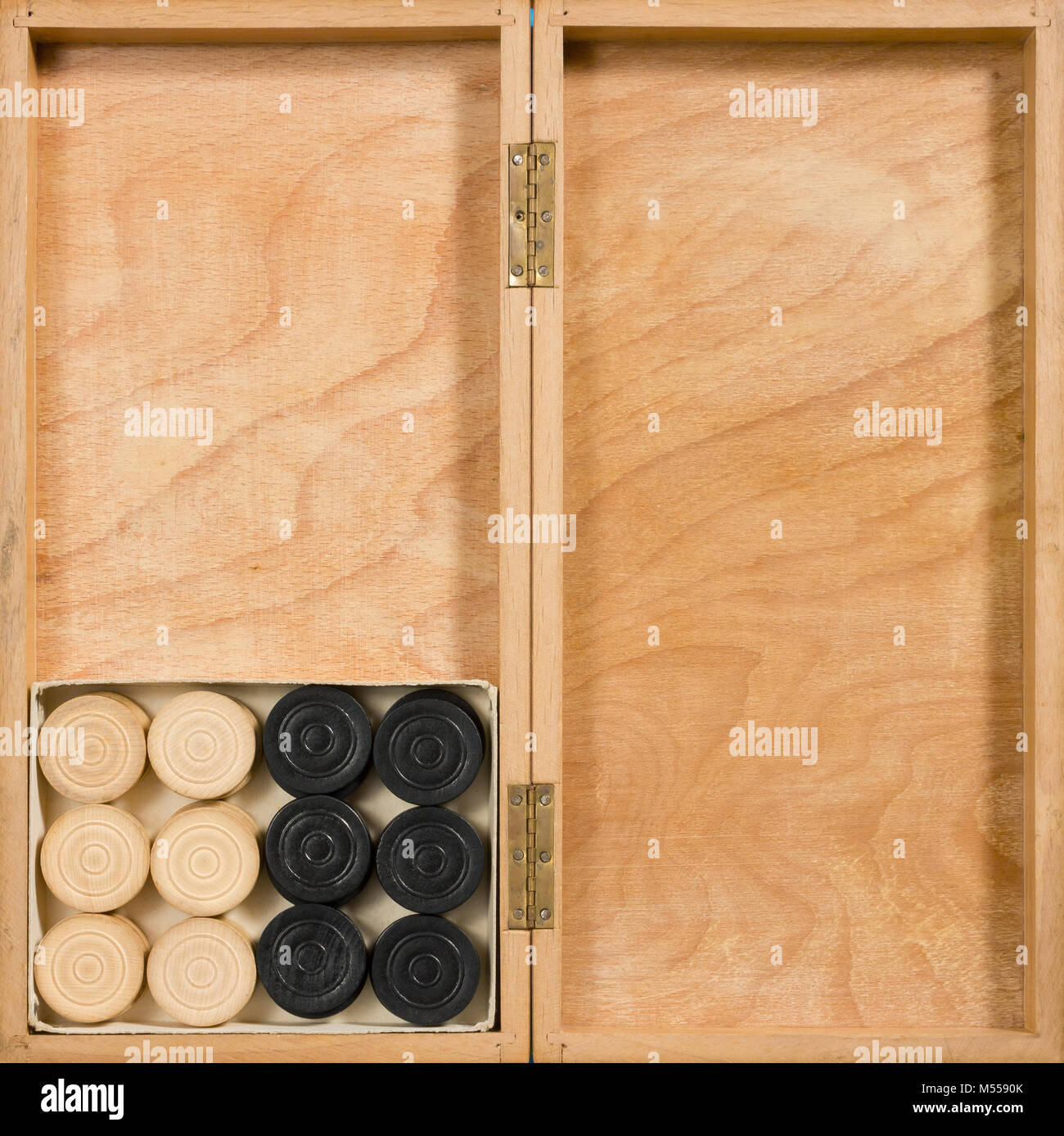Overturned foldable wooden checkers board with a cardboard box ...