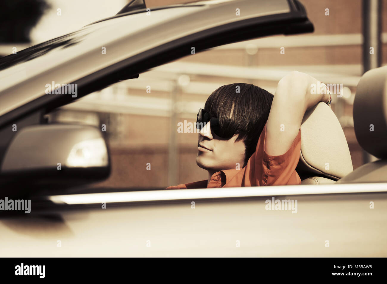 Young man driving a convertible car Stock Photo - Alamy