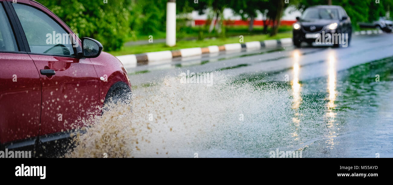 car rain puddle splashing water Stock Photo - Alamy