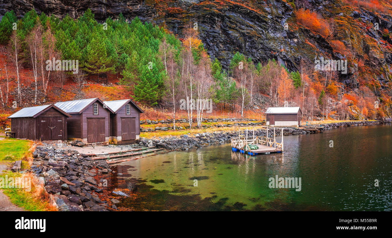 Three wooden huts on the shore of a fiord Stock Photo - Alamy