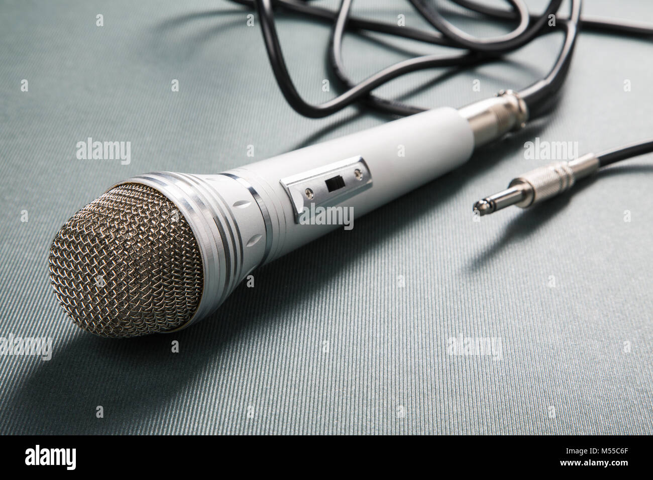 Microphone silver with a wire on a ridge background Stock Photo - Alamy