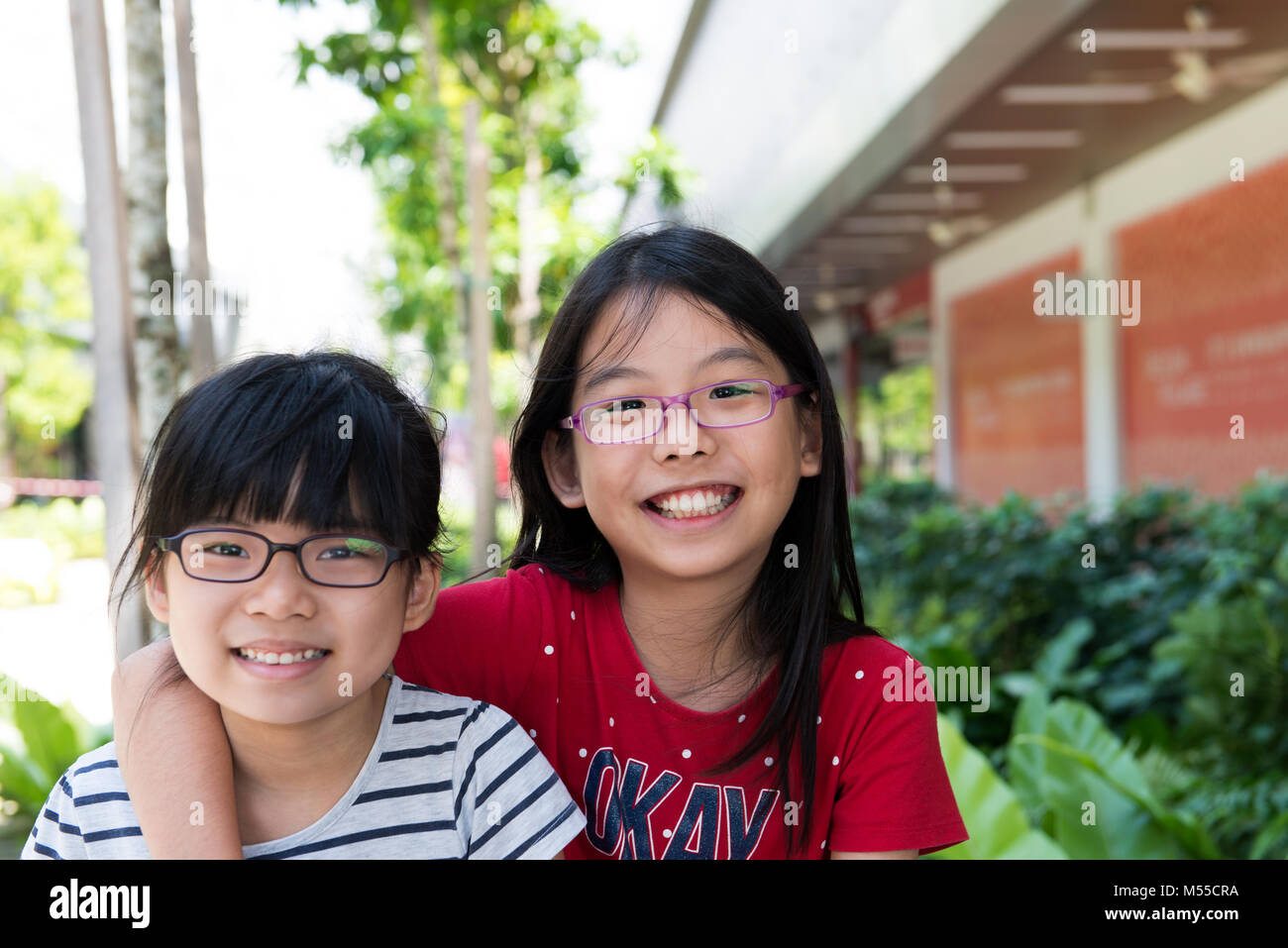 Two cheerful sister child Stock Photo - Alamy