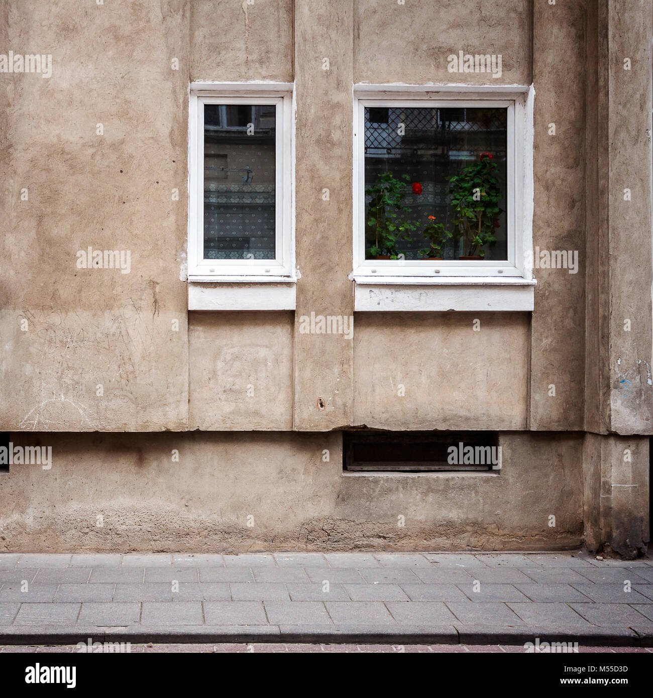 Aged weathered street wall with some windows Stock Photo - Alamy