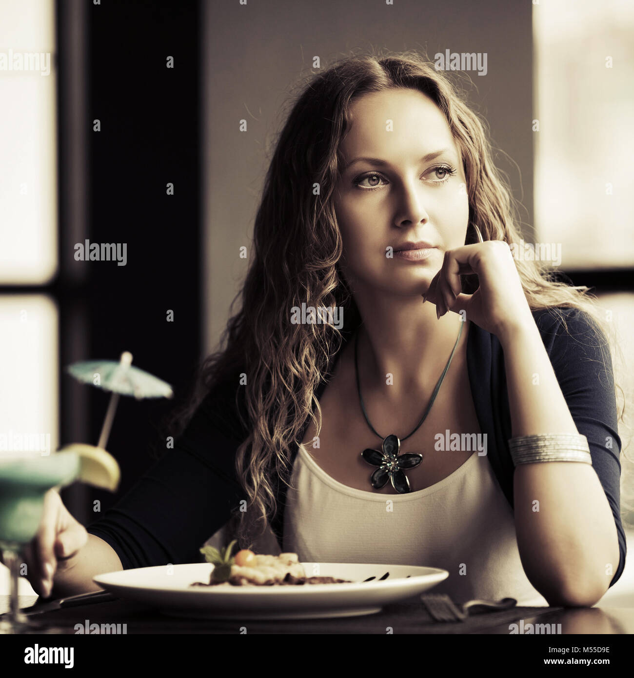 Beautiful young woman dining at restaurant Stock Photo - Alamy