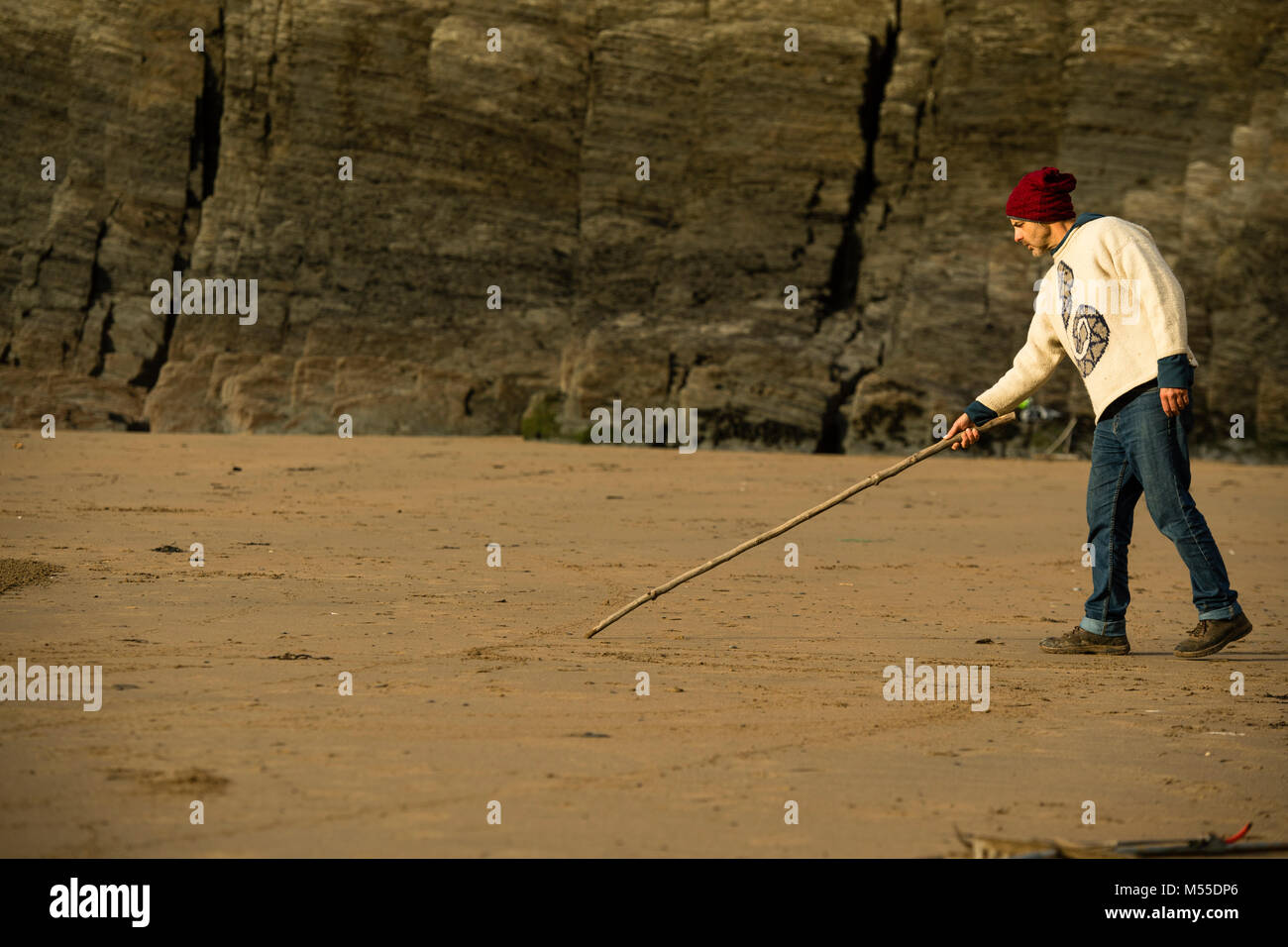 MARC TREANOR, sand artist, working on one of his huge , but ephemeral ...