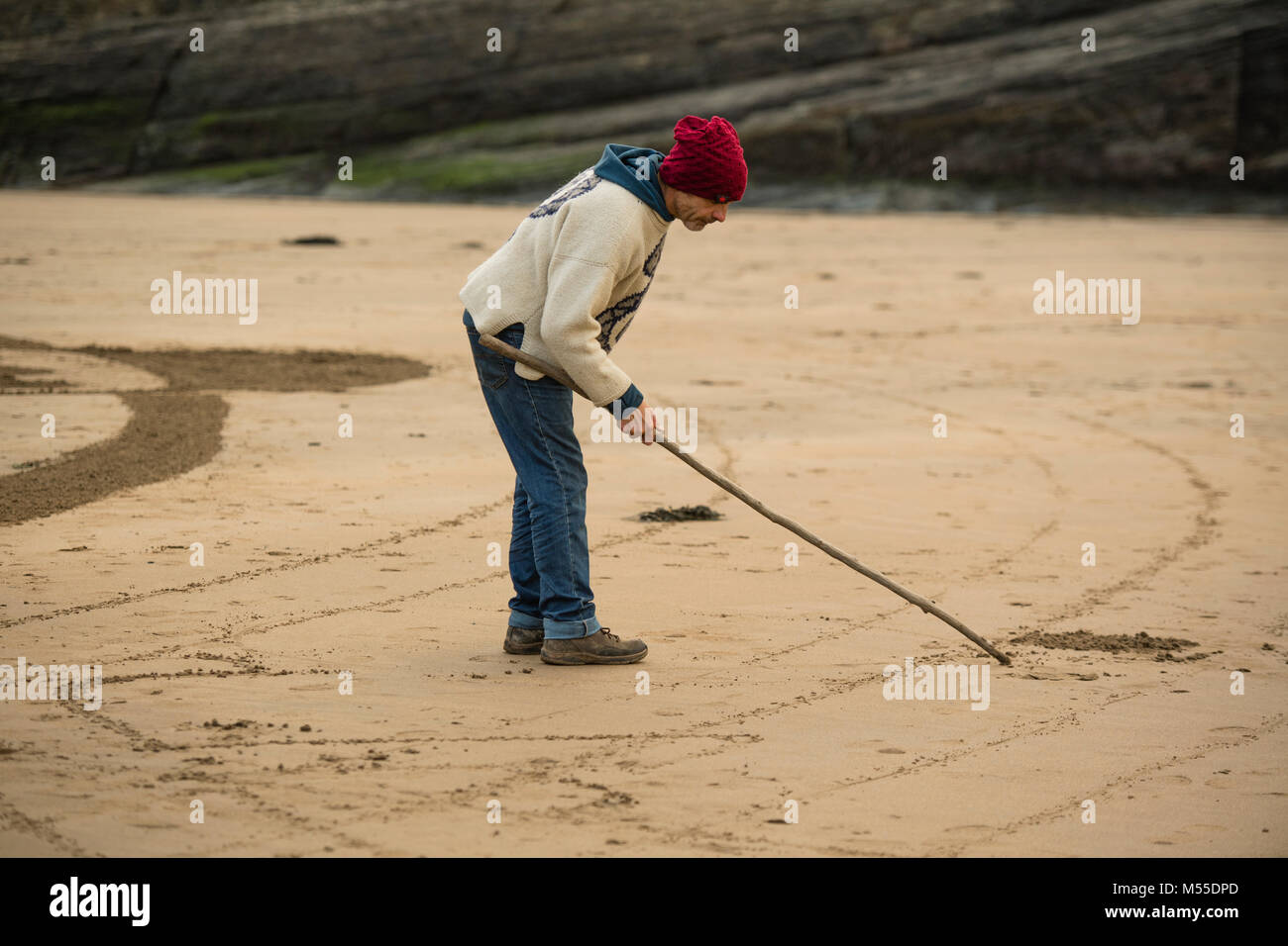 MARC TREANOR, sand artist, working on one of his huge , but ephemeral ...