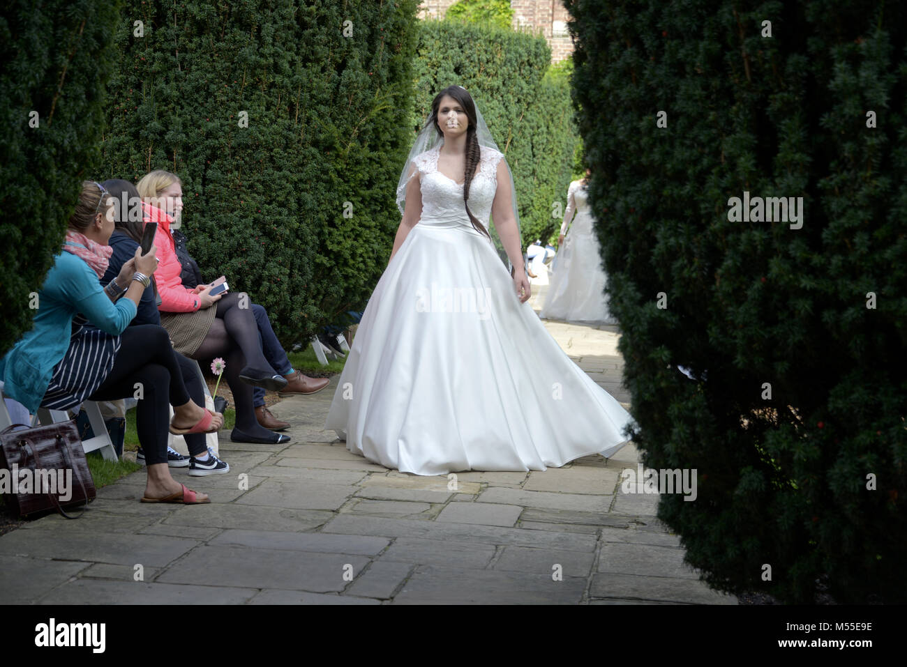 Beautiful Models wearing Bridal wear are walking on a catwalk at ...