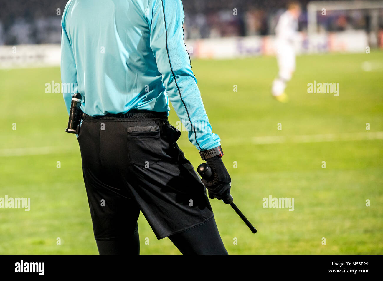 Assistant referees signalling on the sideline during a soccer match ...